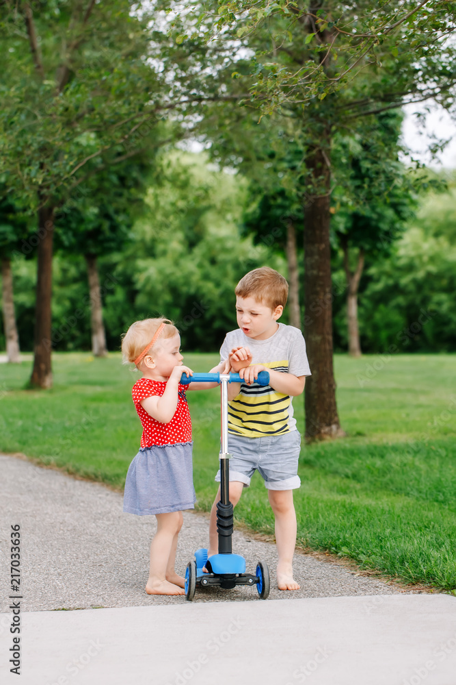 Two little Caucasian preschool children fighting in park outside. Boy ...