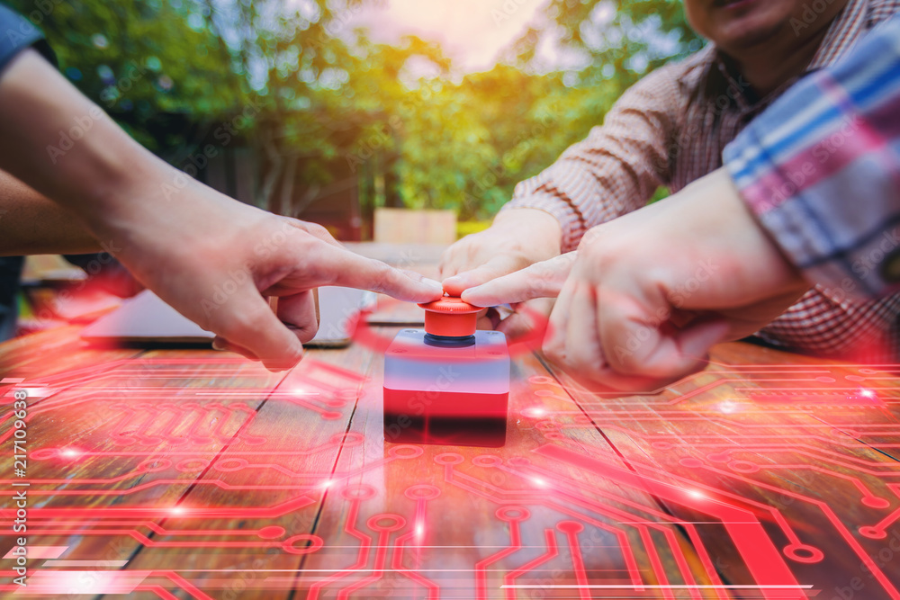 Multiple hands join for push the emergency stop button for stop circuit ...