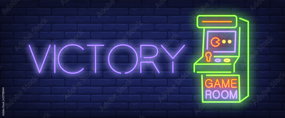 Victory game room neon text with arcade game machine. Technology and ...