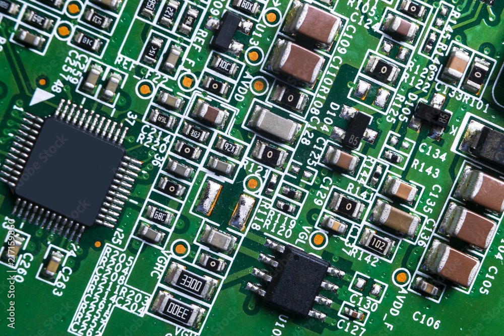 Macro shot of a Circuitboard with resistors microchips and electronic ...