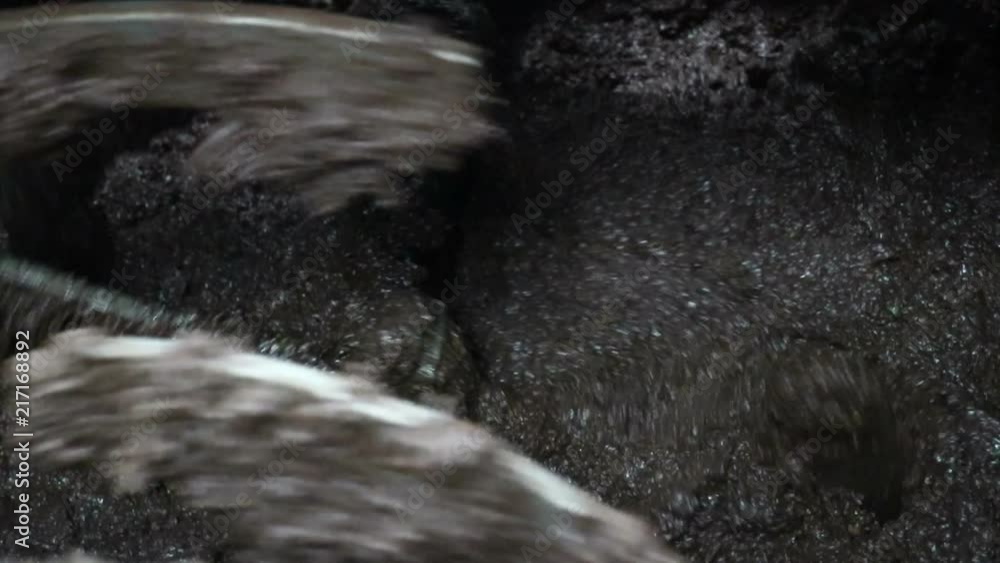 Traditional olive oil processing with crushing the olives into a paste ...