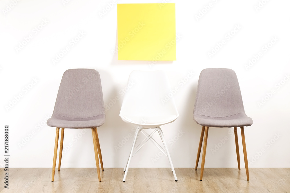 Three empty available loft style chair seats on wooden floor with blank ...