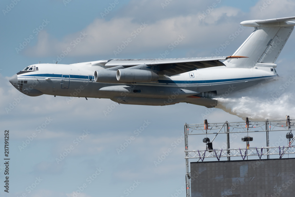 Four-engine heavy cargo plane in the sky. The plane to extinguish fires ...