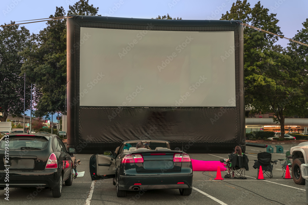 Spectators for car parking with cars, an inflatable screen of the ...