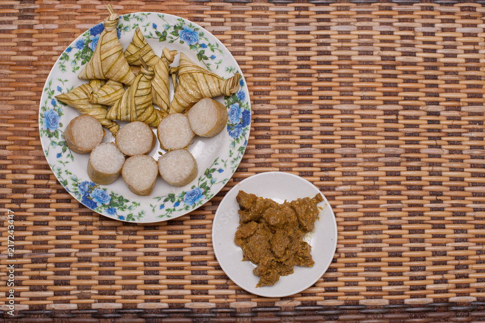 Lemang and ketupat (bamboo rice and rice dumpling) with rendang on ...