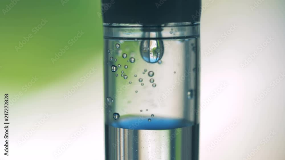 Droplets of water are falling in a vessel. Dropper counter with ...