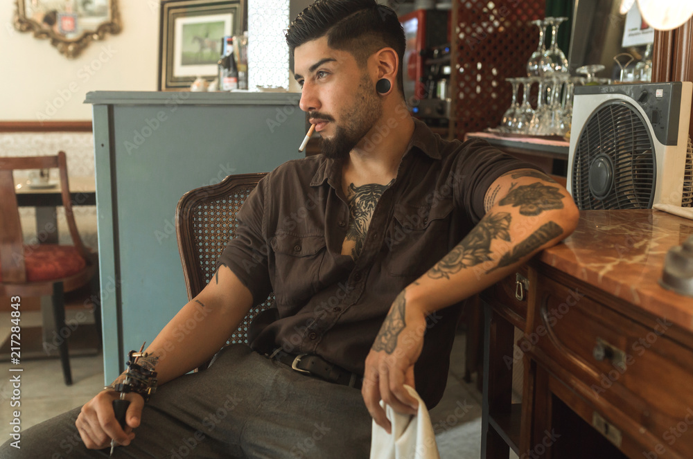 Vintage men tattooing and posing in a retro bar Stock Photo | Adobe Stock