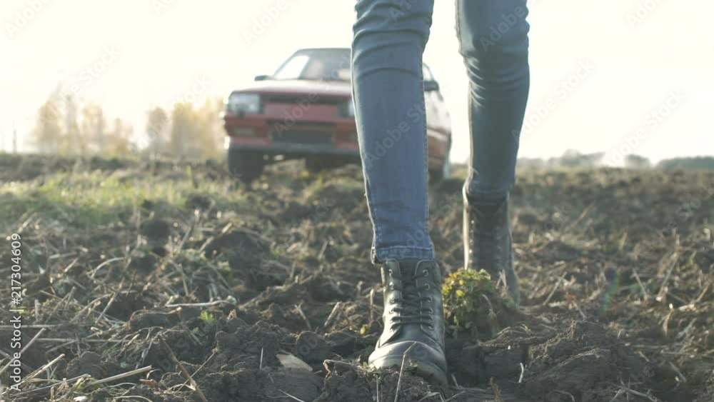Girl threw the car in the field, A girl is walking along the field ...