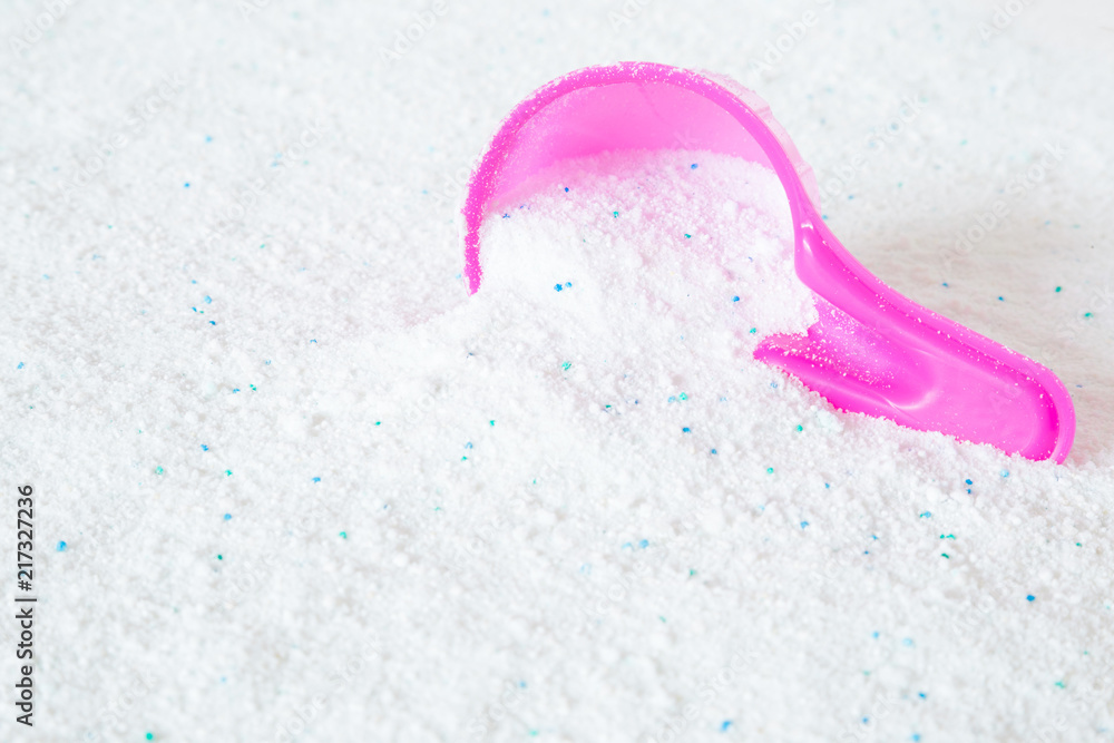 Pink cup or scoop of white powder. Detergent for clothes washing. Dry ...