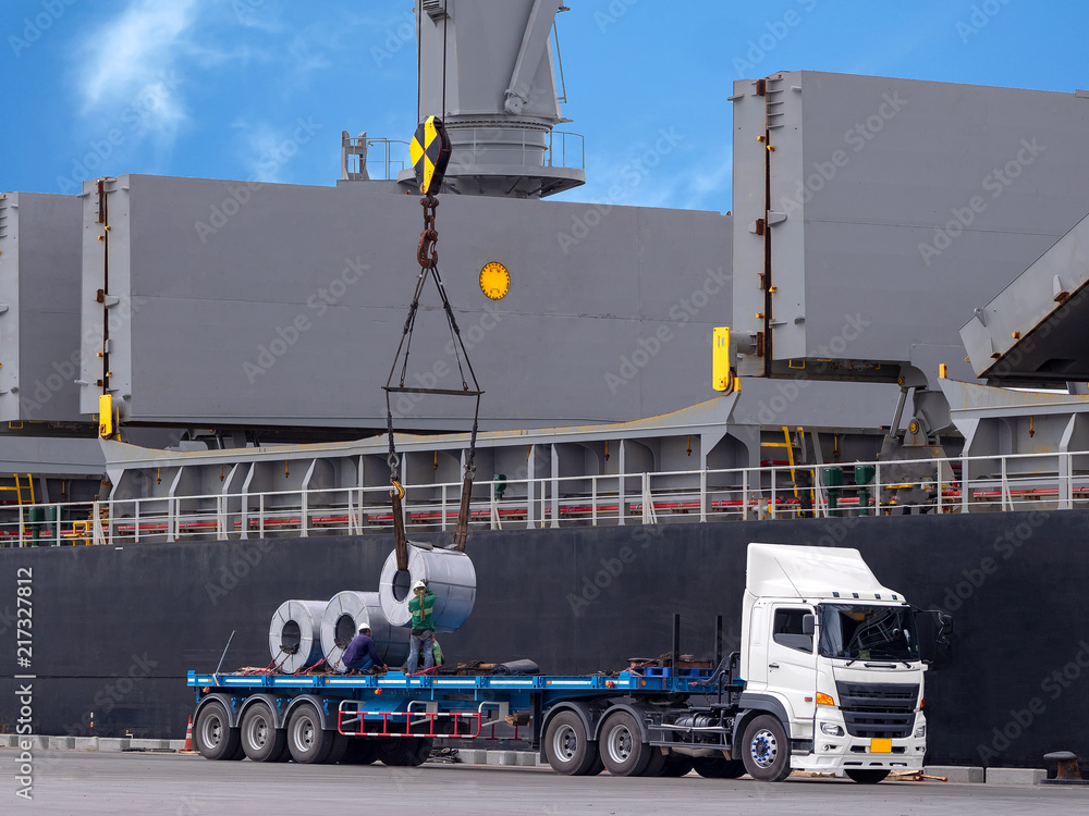 Poster The vessel discharging steel coils on truck at industrial port ...