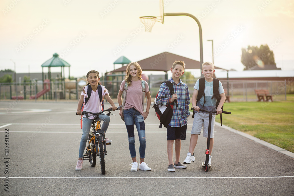Group of smiling elementary school students on their way home. Back to ...