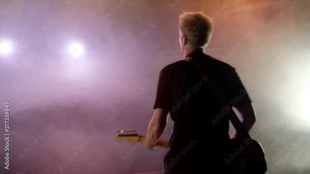 Concert rock band performing on stage with singer guitar. Music video ...