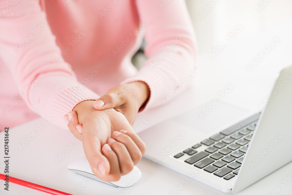 Closeup woman holding her wrist pain from using computer. Office ...