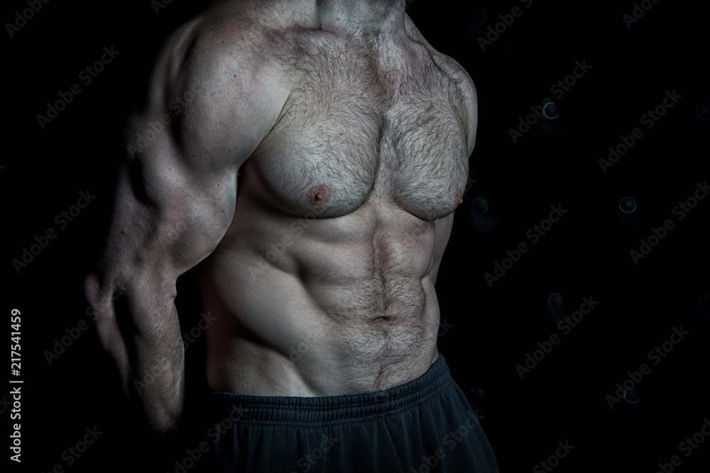 Preparing muscles for actions. Torso with six packs looks attractive on ...
