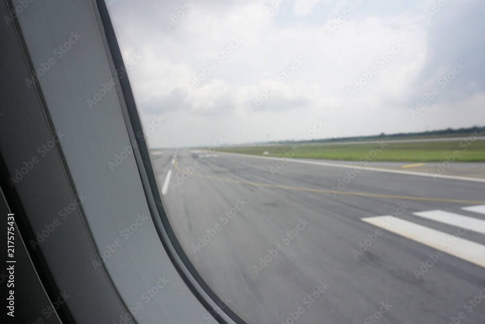 Plane window view during take off with airplane runaway tarmac Stock ...