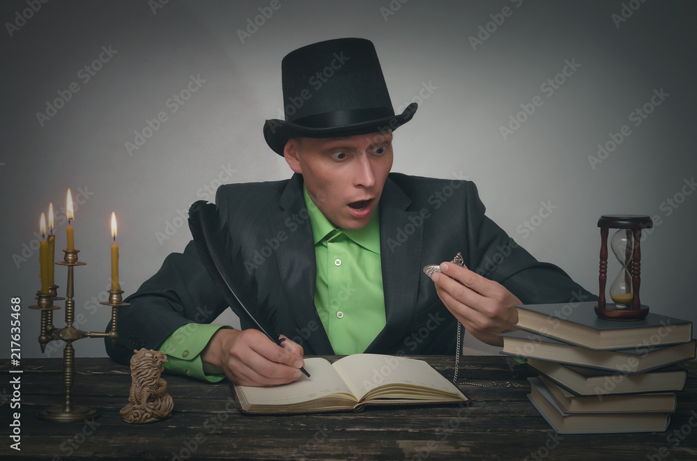 Shocked man in bowler hat and suit is sitting by table and showing a ...