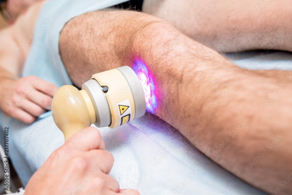 Ultrasound treatment in physical therapy. Physiotherapist doctor using ...