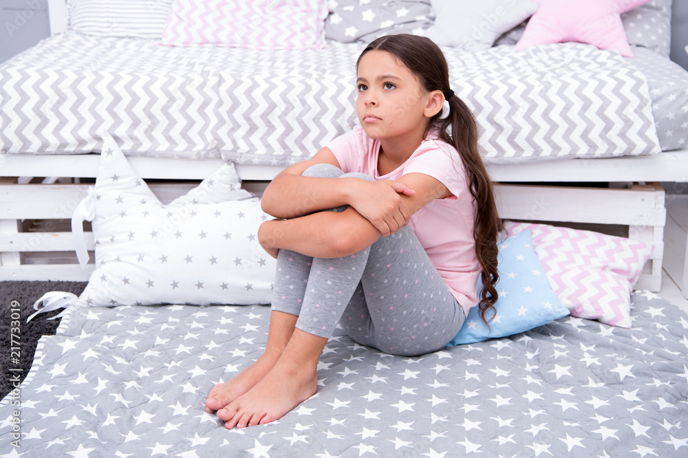 Sad concept. Sad little girl. Sad child sit on bed. Sad kid in bedroom ...