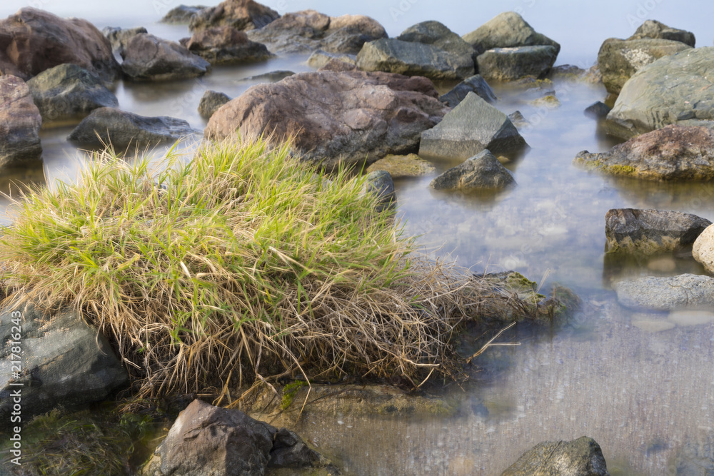 The beach with stones. Big stones on the beach. Morning inflow of water ...