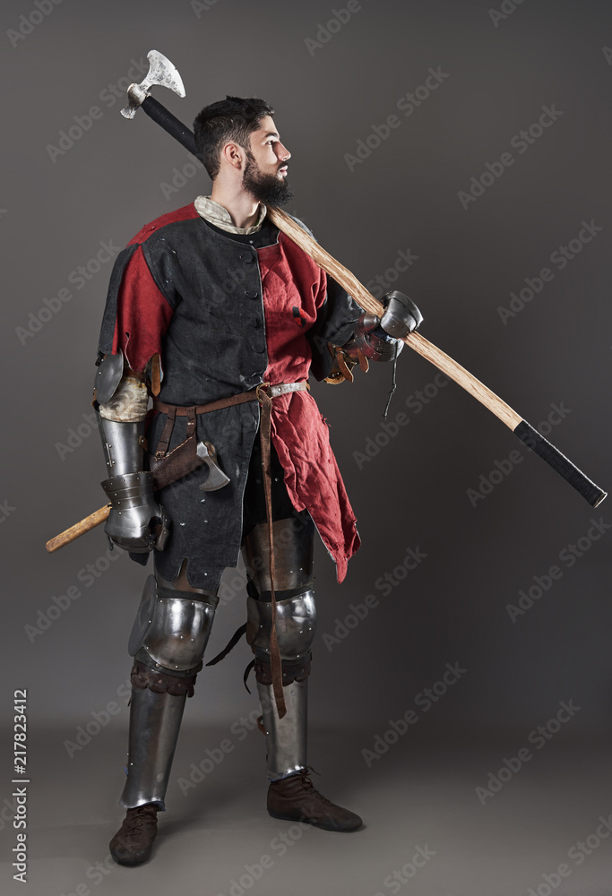 Medieval knight on grey background. Portrait of brutal dirty face ...