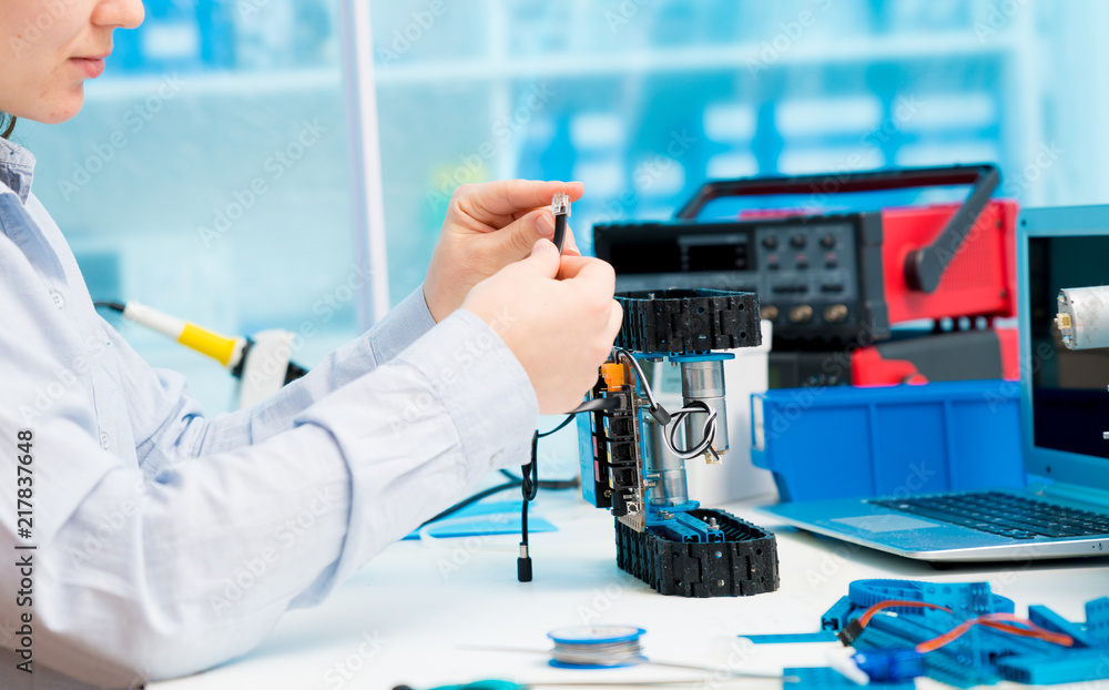 Student girl in electronics laboratory, experiment with microcontroller ...