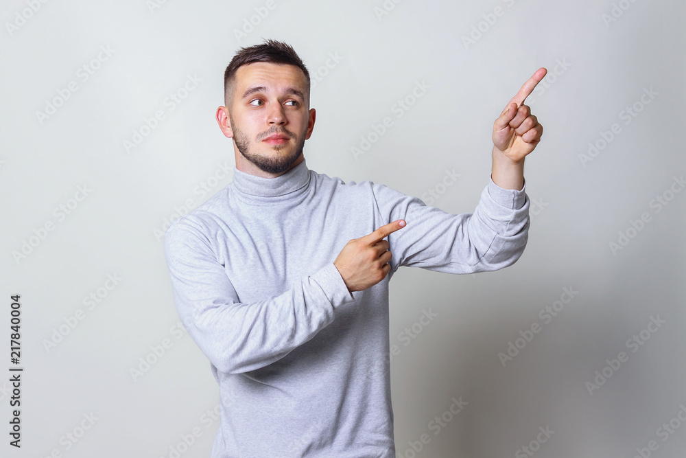 Young man pointing or show direction. The man points with both hands ...