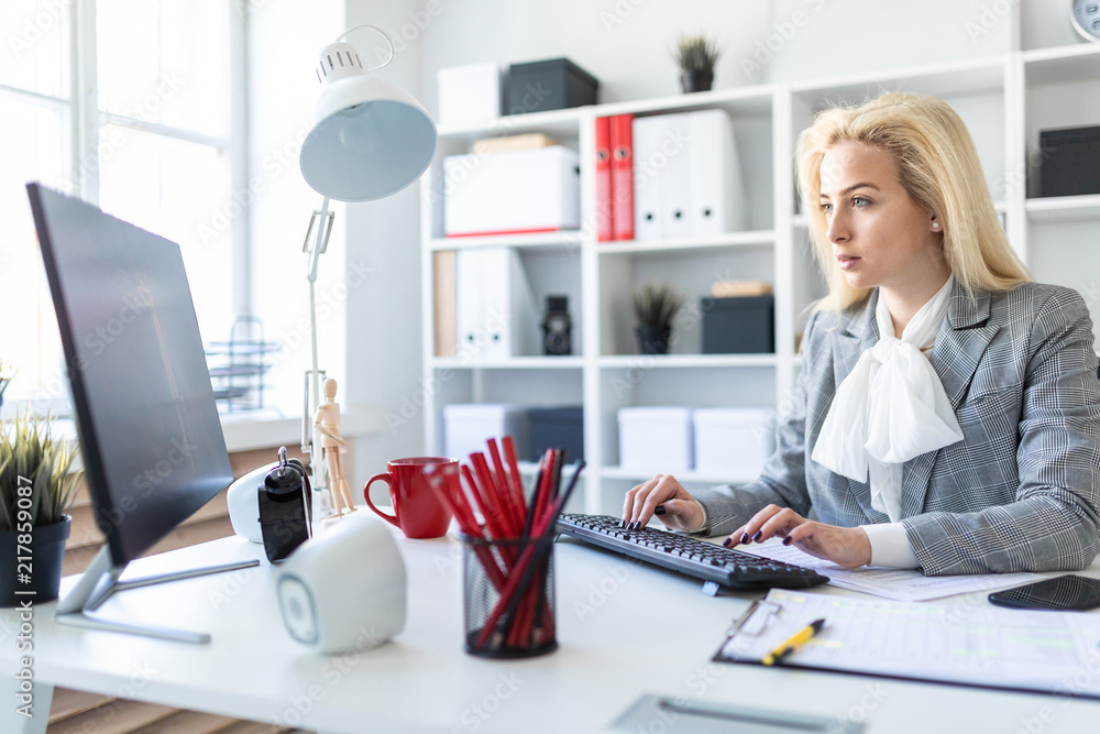 Young girl in office working with computer and documents. Stock Photo ...