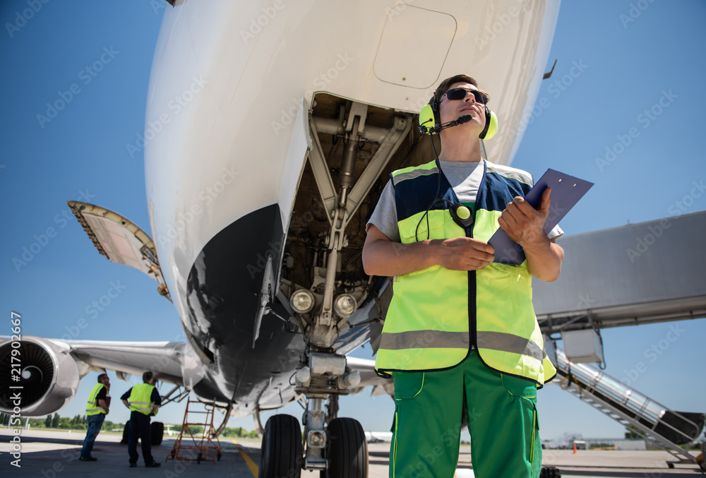 Preparation for the flight. Low angle portrait of man in sunglasses ...