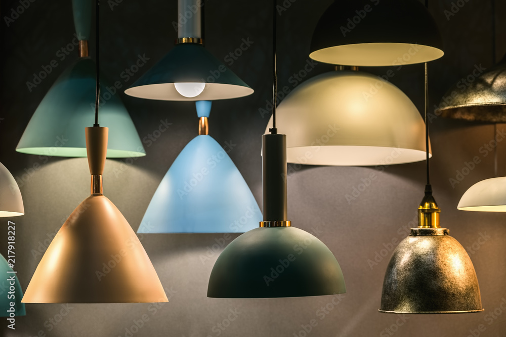 Display of many hanging lamps with colorful lamp shade sizes and colors ...