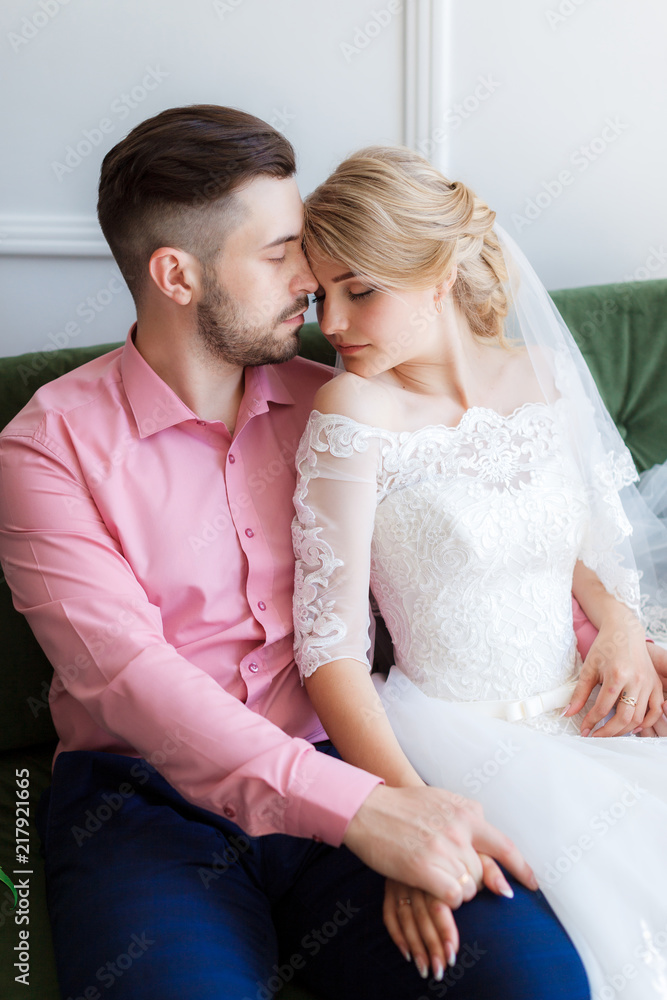 Happy wedding couple hugging and kissing. Beautiful young bride and ...
