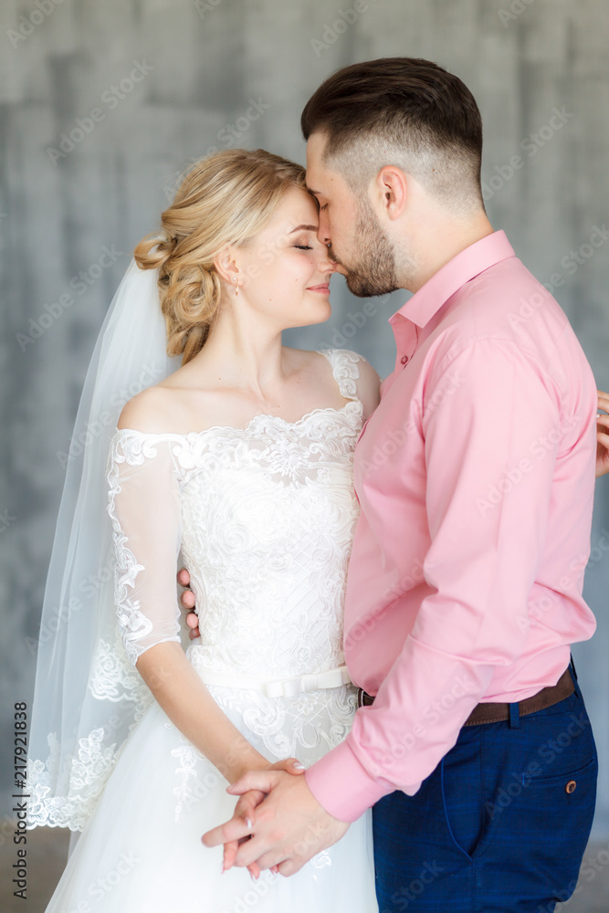 Happy wedding couple hugging and kissing. Beautiful young bride and ...
