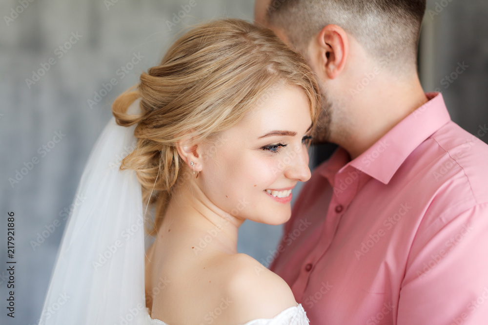 Happy wedding couple hugging and kissing. Beautiful young bride and ...