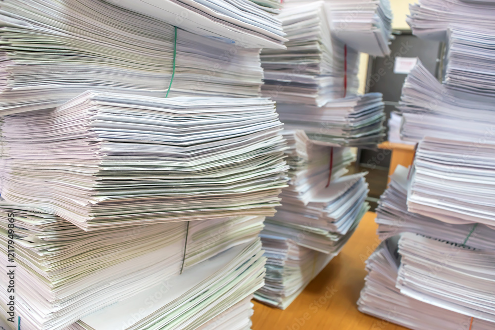bundles bales of paper documents. stacks packs pile on the desk in the ...