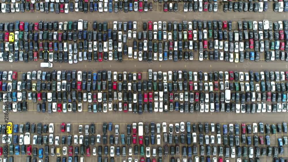 Aerial top down footage automaker car lot showing vehicles parked close ...