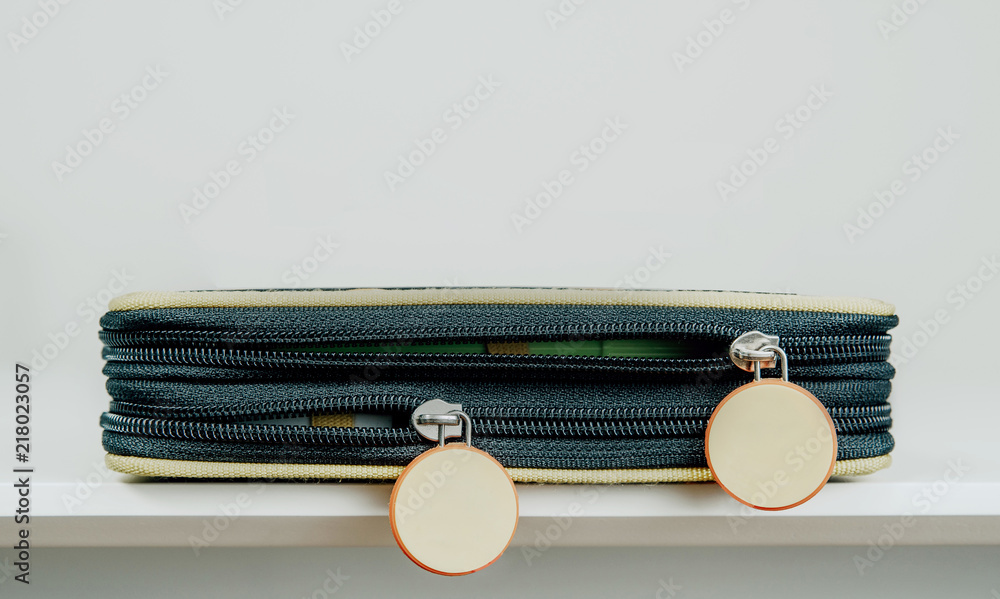 Closed yellow pencil case with a circular zip. The concept of returning ...