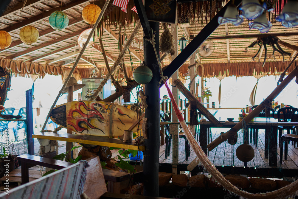 Traditional hippie bar at the shore on tropical island in open air with ...