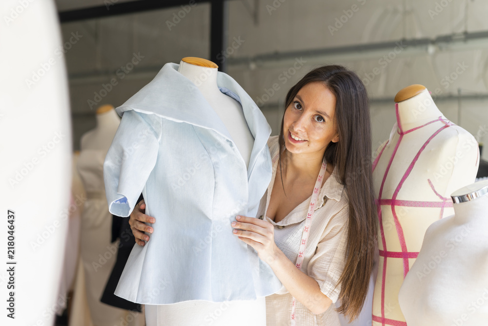 Young fashion designer fitting clothes on dressmaker's model Stock ...