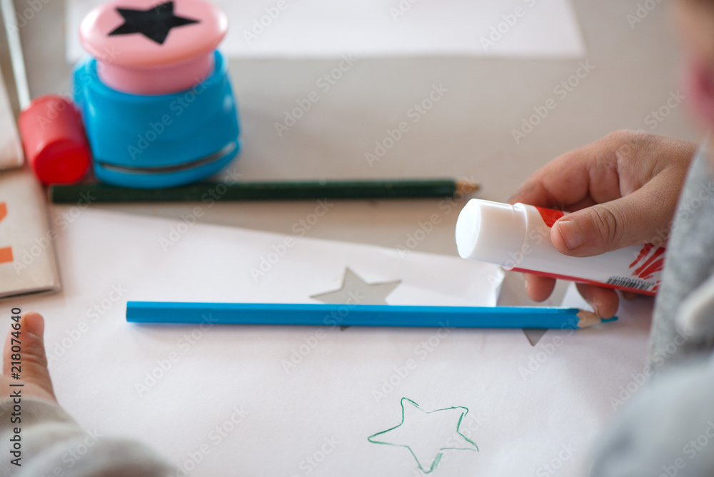Creative workshop for kids. Little girls gluing cut out shapes and ...