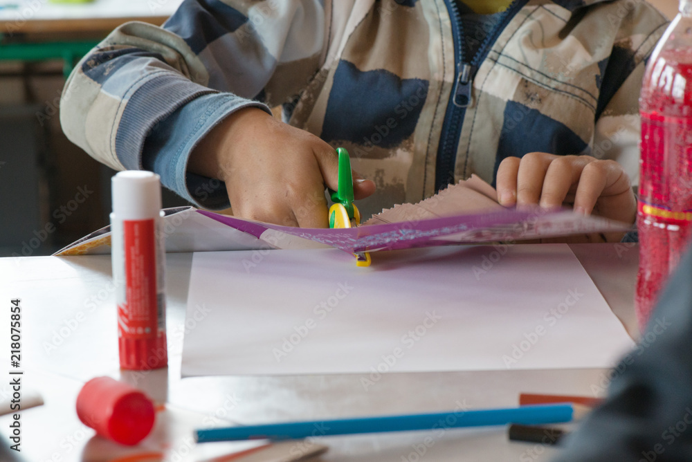 Creative workshop for kids. Little girls gluing cut out shapes and ...