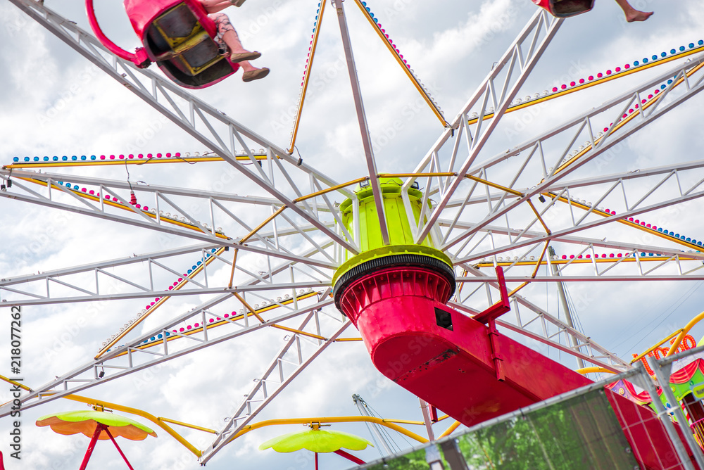Colorful roller coaster seats at amusement park. People having fun in ...