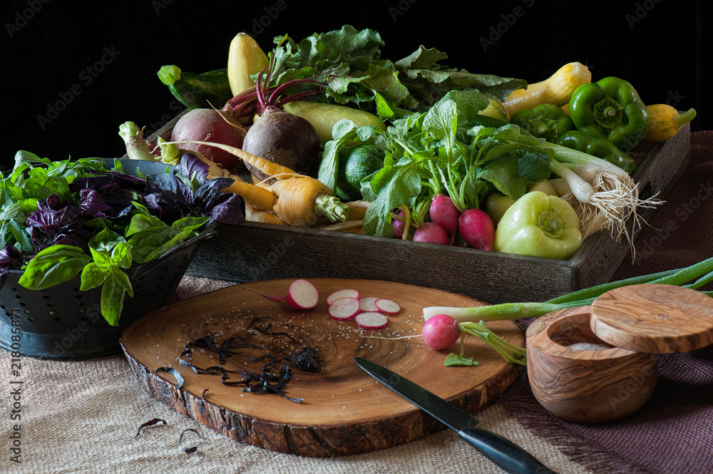 Farm-fresh produce in a kitchen scene complete with wood cutting board ...