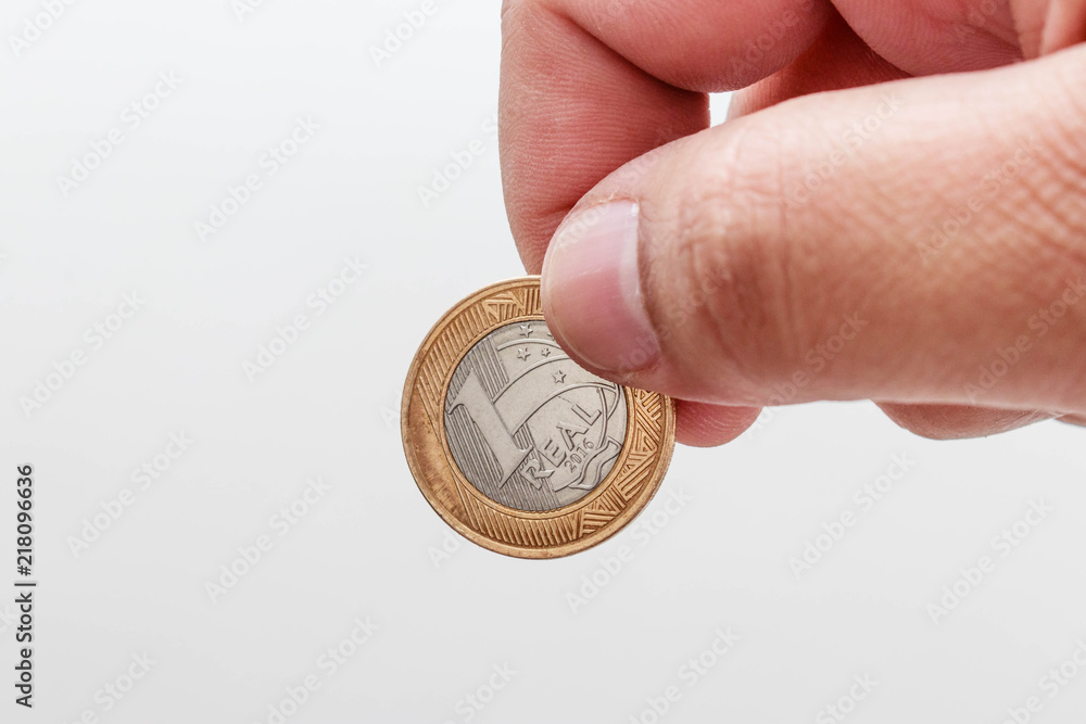 Male hand holding One Real, Brazilian coin white background Stock Photo ...