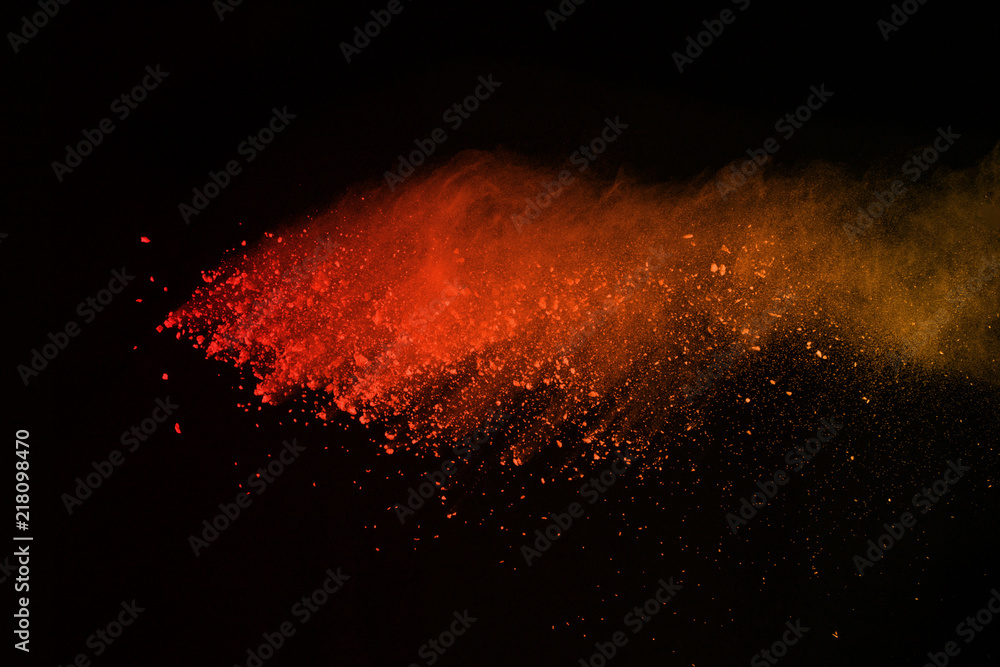Explosion of colored powder isolated on black background. Power or ...