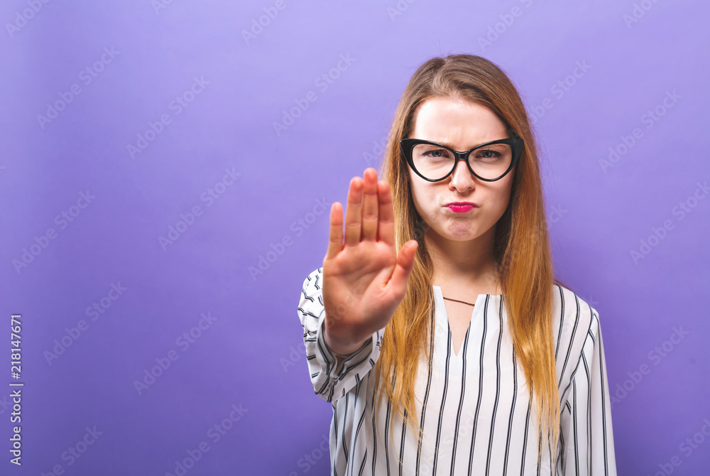 Young woman making a rejection pose on a solid background Stock Photo ...