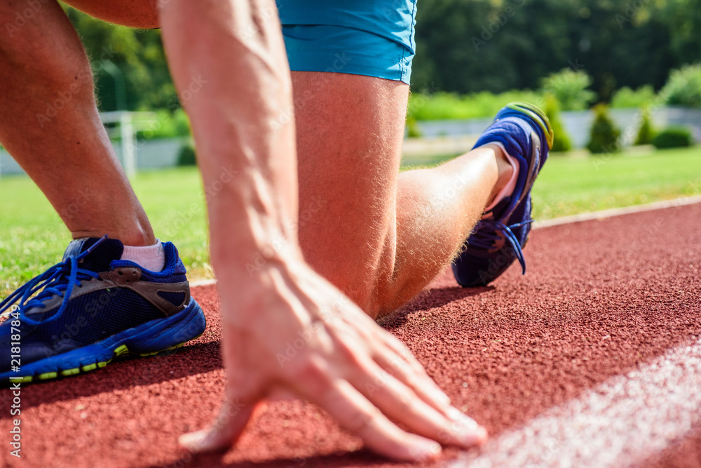 Starting point. Hand of sportsman on running track low start position ...