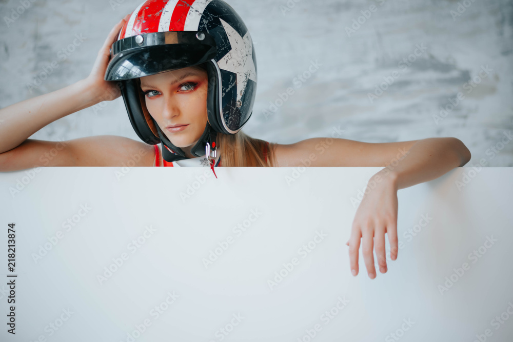Female biker girl with black full face motorcycle helmet.Copy space for ...