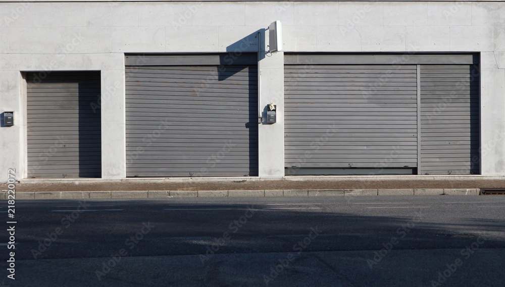 Urban background. Shop retail with metal shutters closed on the ...
