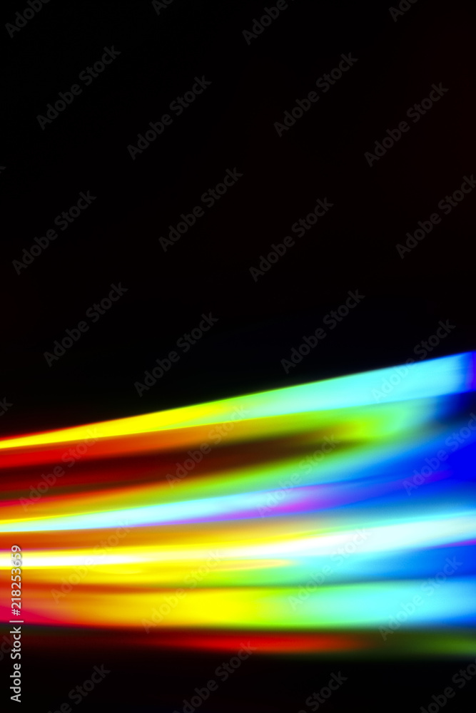 Beams of light refracting and creating a rainbow spectrum of colours ...
