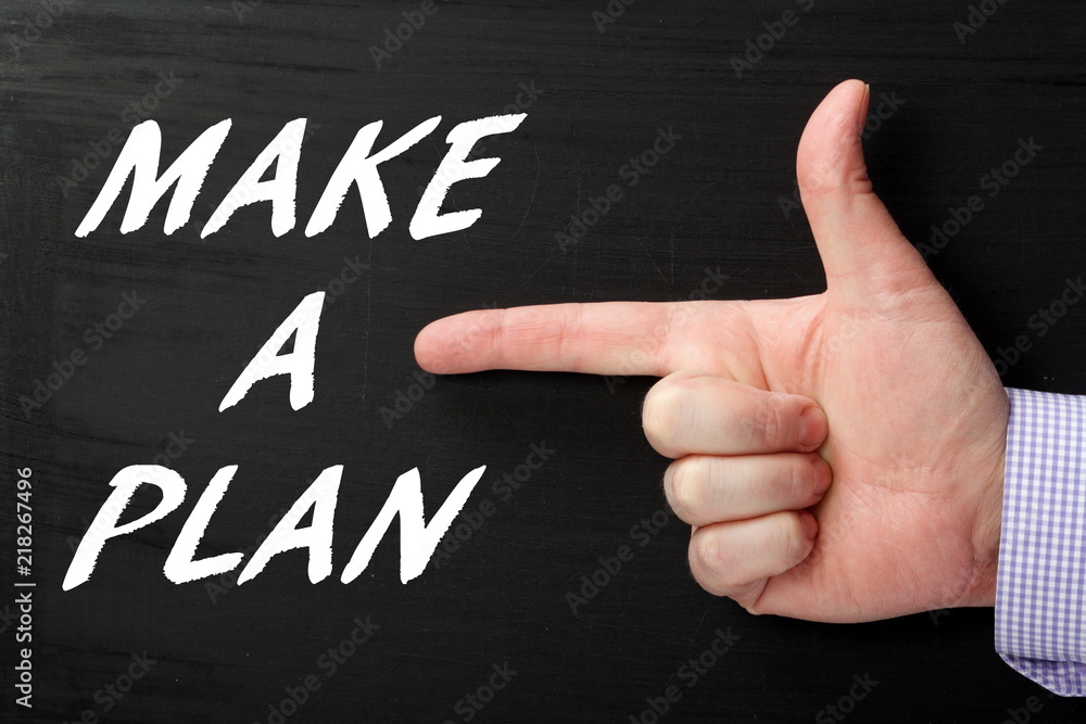 Male hand pointing index finger at the phrase Make A Plan in white text ...