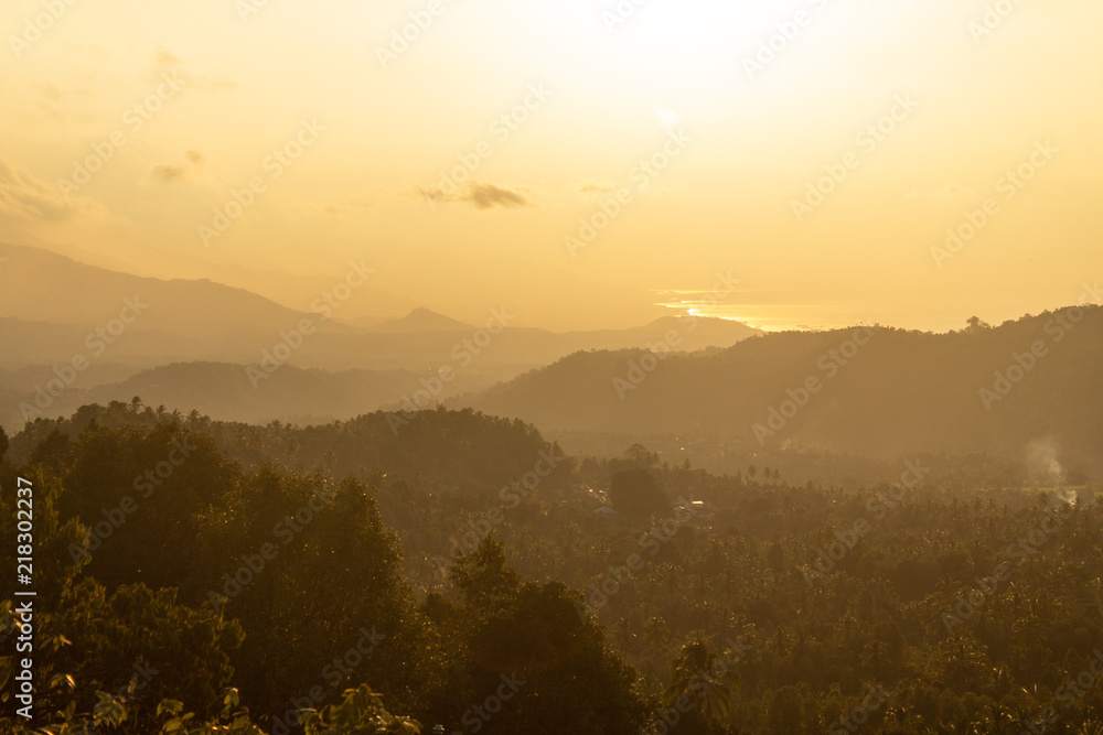 Epic and emotional orange sunset across mountains in asia with warm and ...